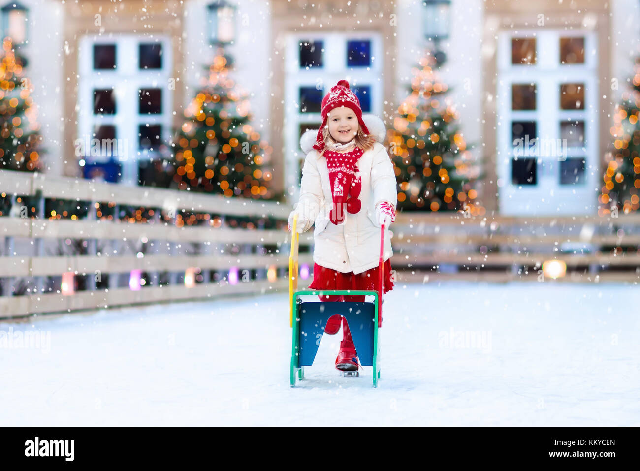 Kids ice skating in winter park rink. Children ice skate on Christmas ...