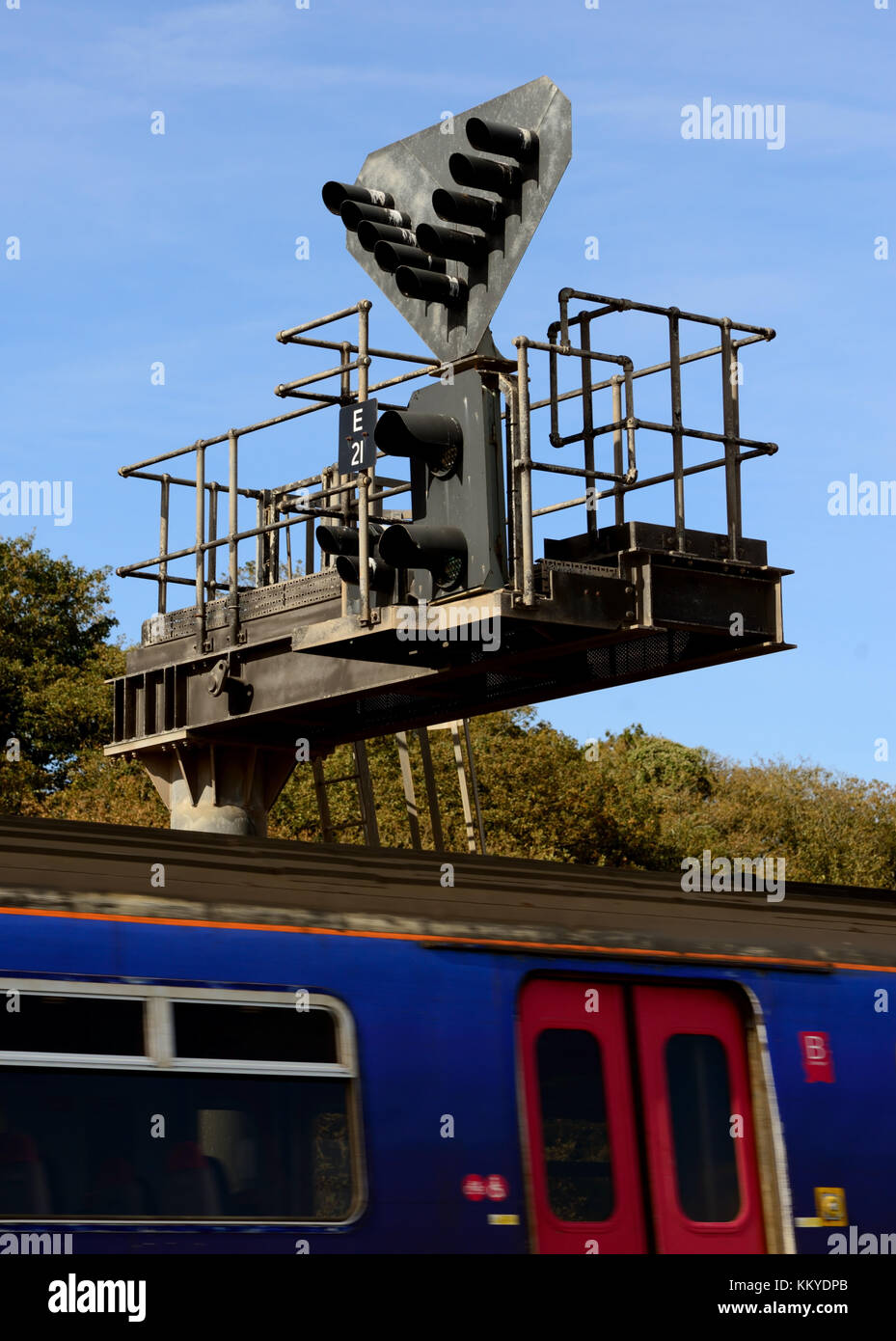 A high speed train passing under a signal gantry at Dawlish Warren ...