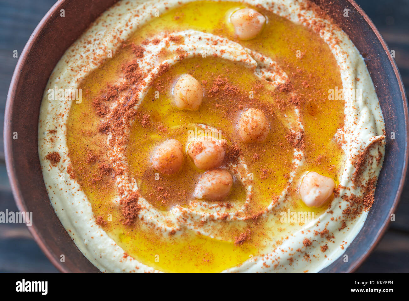 Bowl of hummus on the wooden table Stock Photo - Alamy