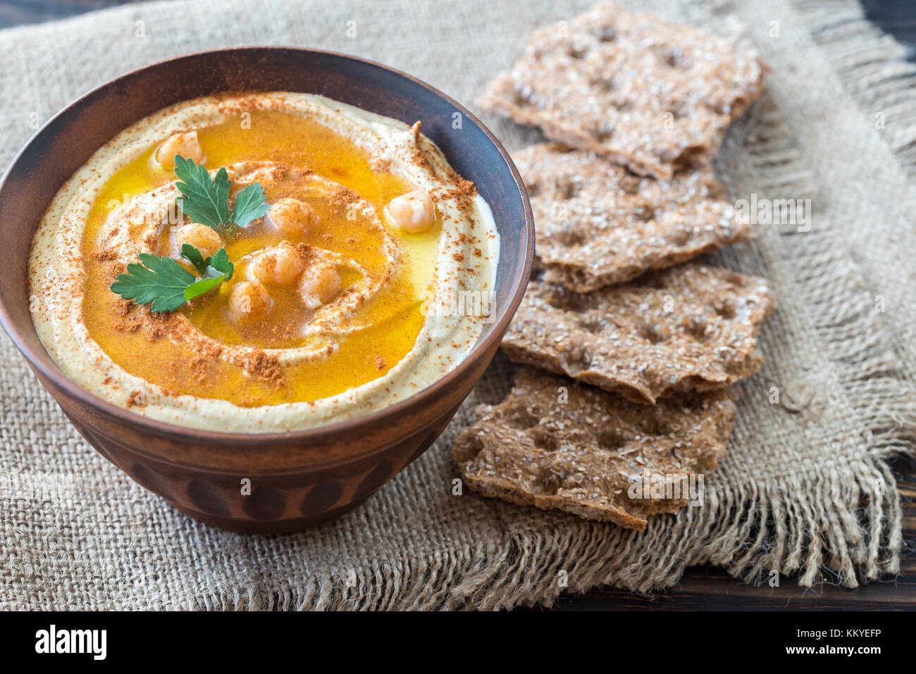 Bowl of hummus on the wooden table Stock Photo - Alamy
