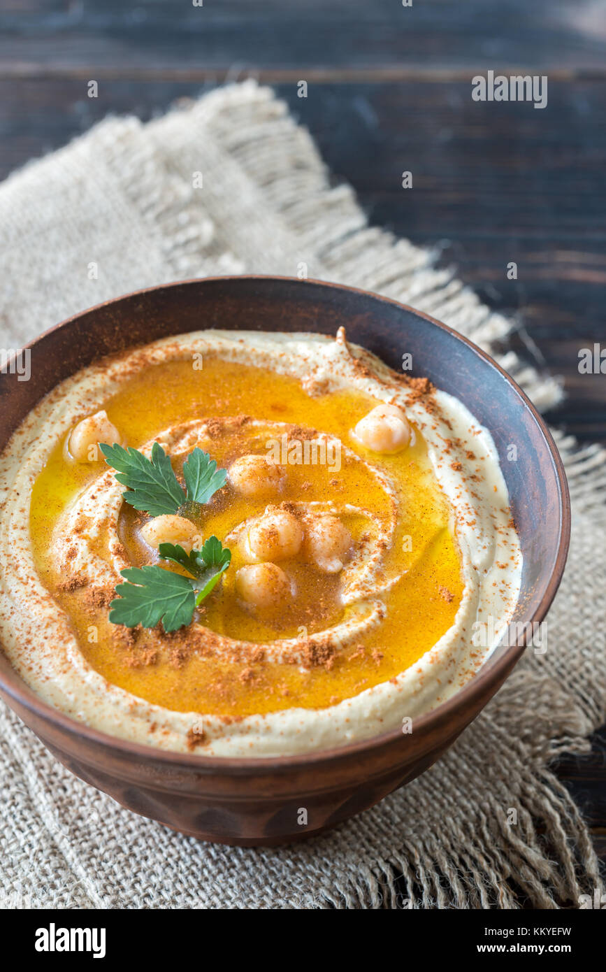 Bowl of hummus on the wooden table Stock Photo - Alamy