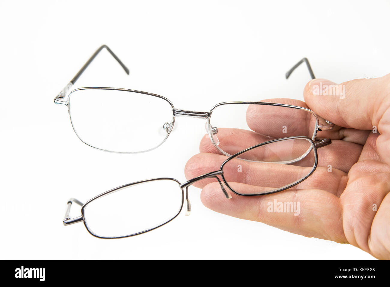 Eye glasses metal frame in the hand on white background Stock Photo - Alamy