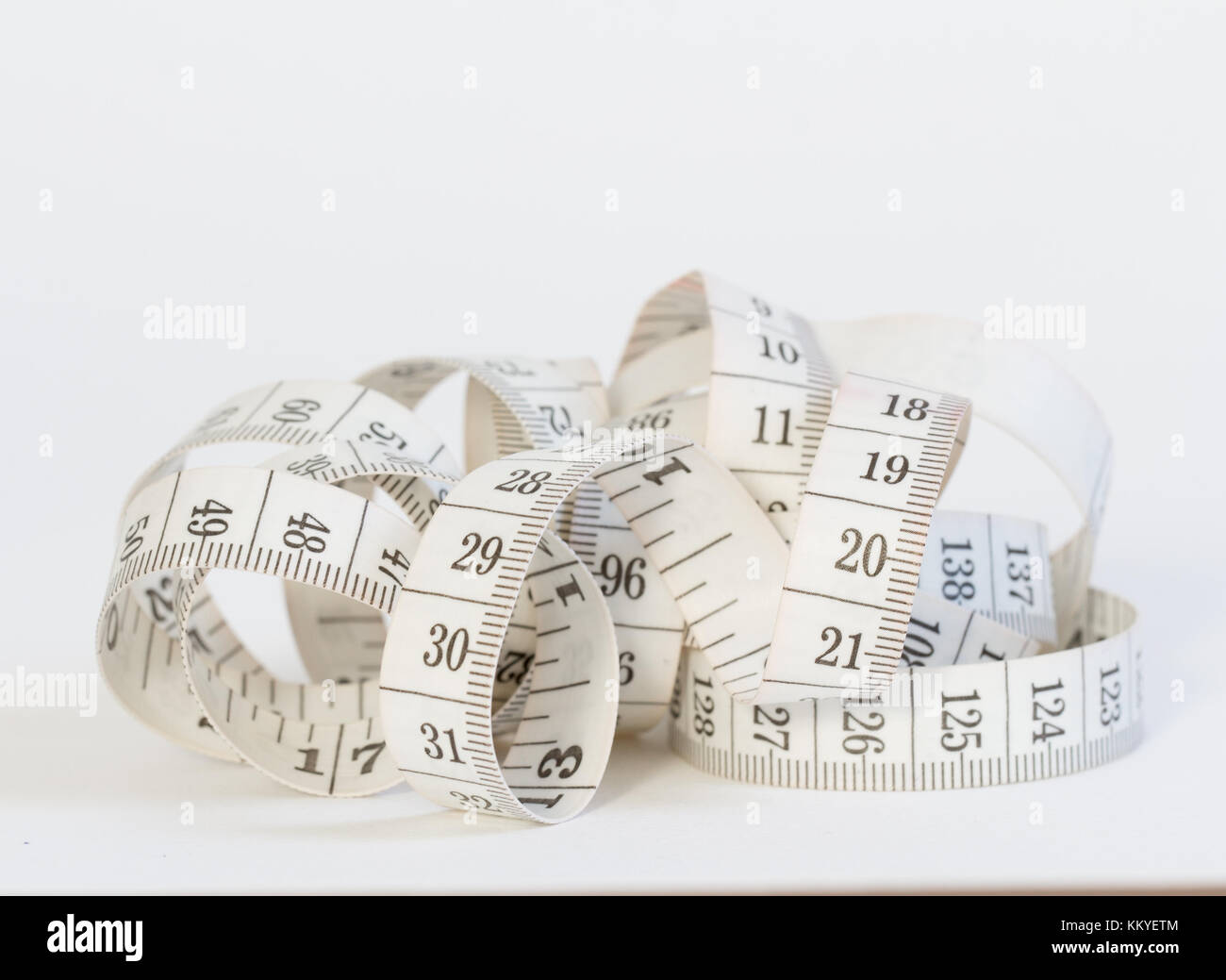 white measuring tape meter with white background Stock Photo - Alamy