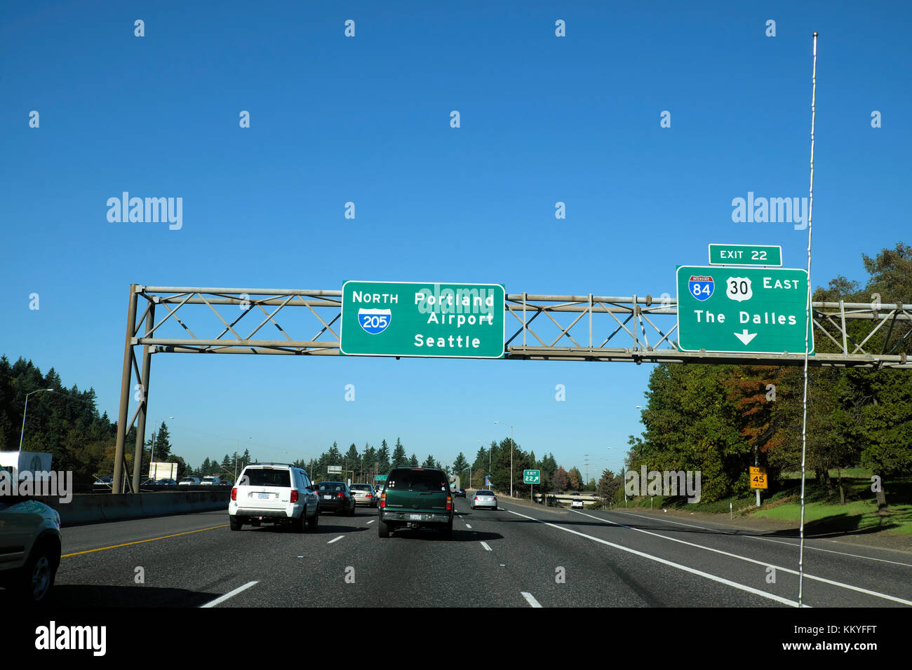 Cars in traffic driving under highway signs on the way to Portland ...