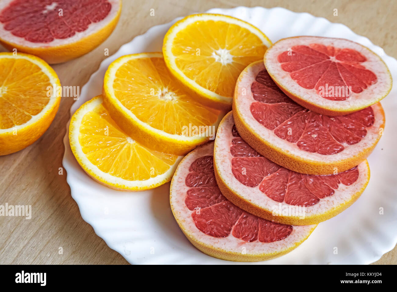 On a plate of sliced orange and grapefruit. Presents closeup Stock ...