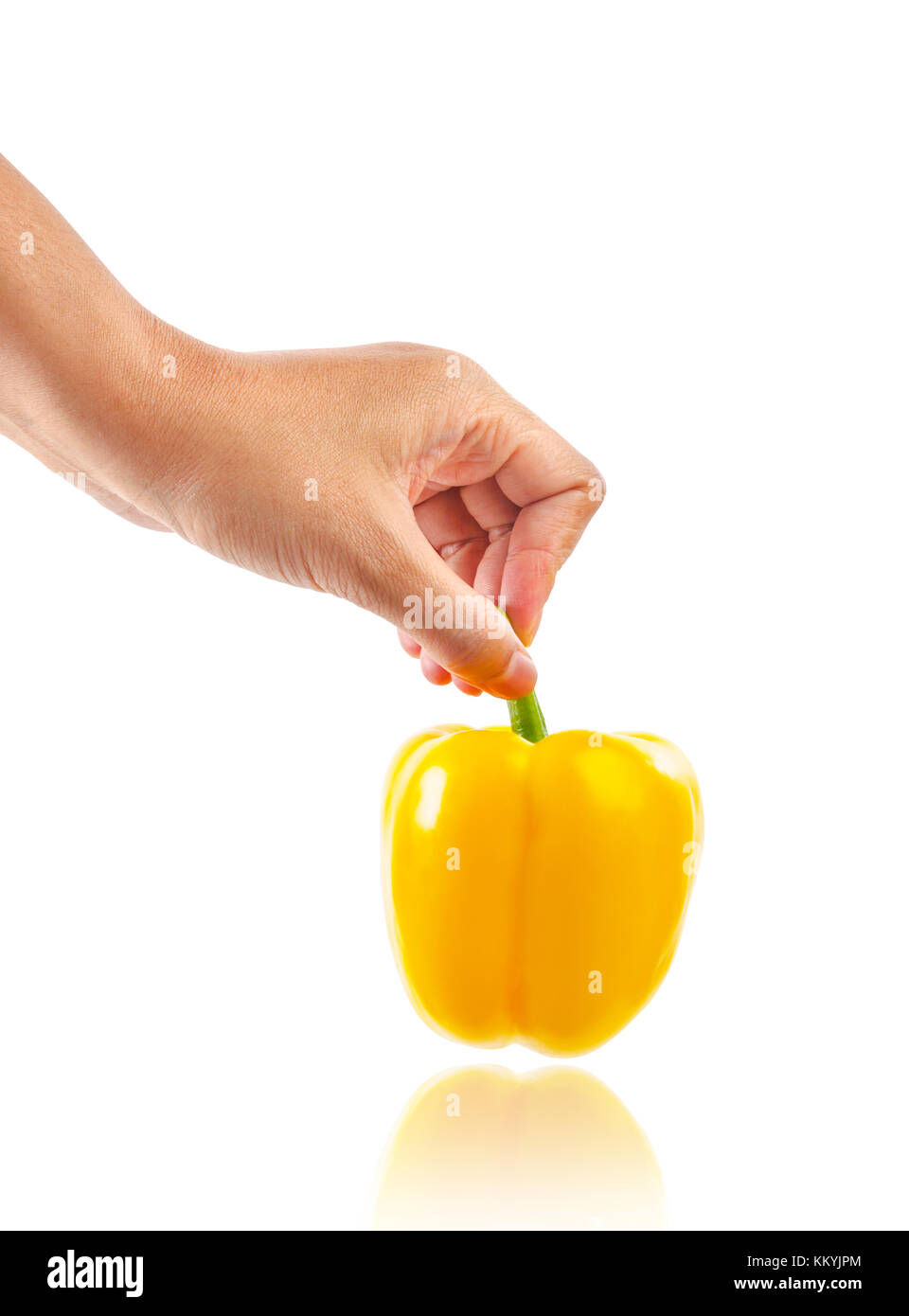 Human hand holding yellow pepper isolated on a white background, Saved ...