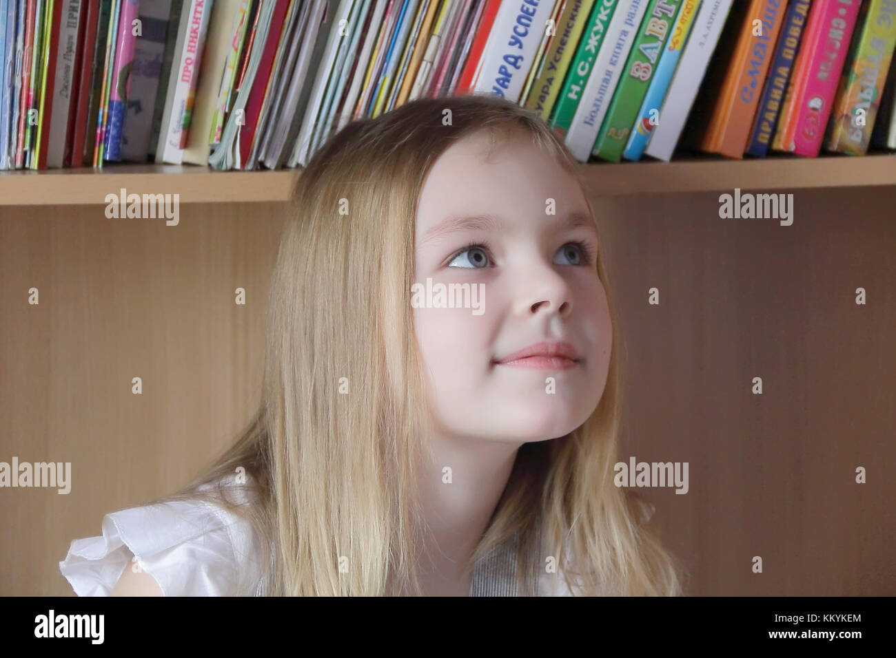 Portrait of beautiful girl on book background Stock Photo - Alamy
