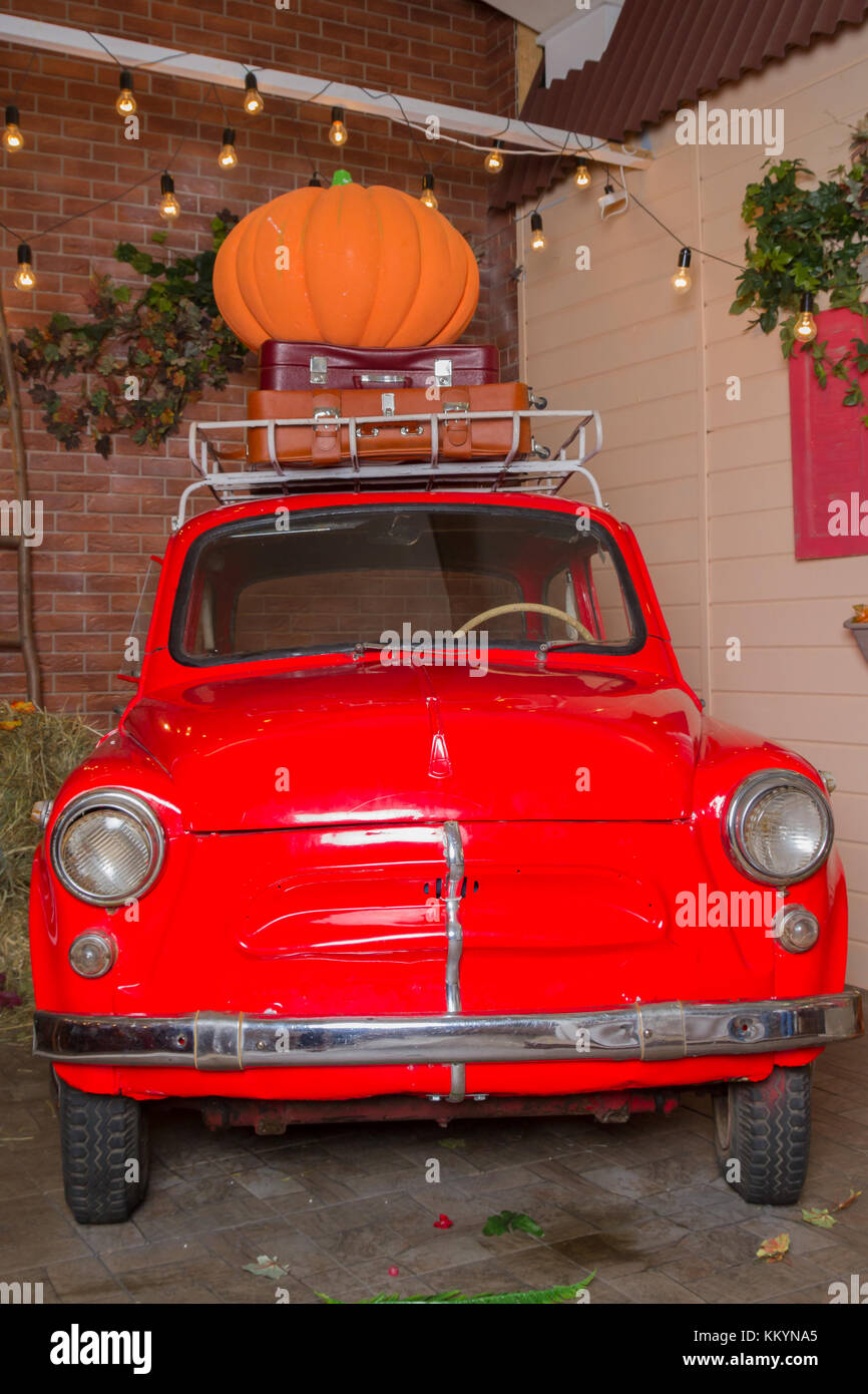 Retro red car on autumn scenery in front of the house Stock Photo - Alamy