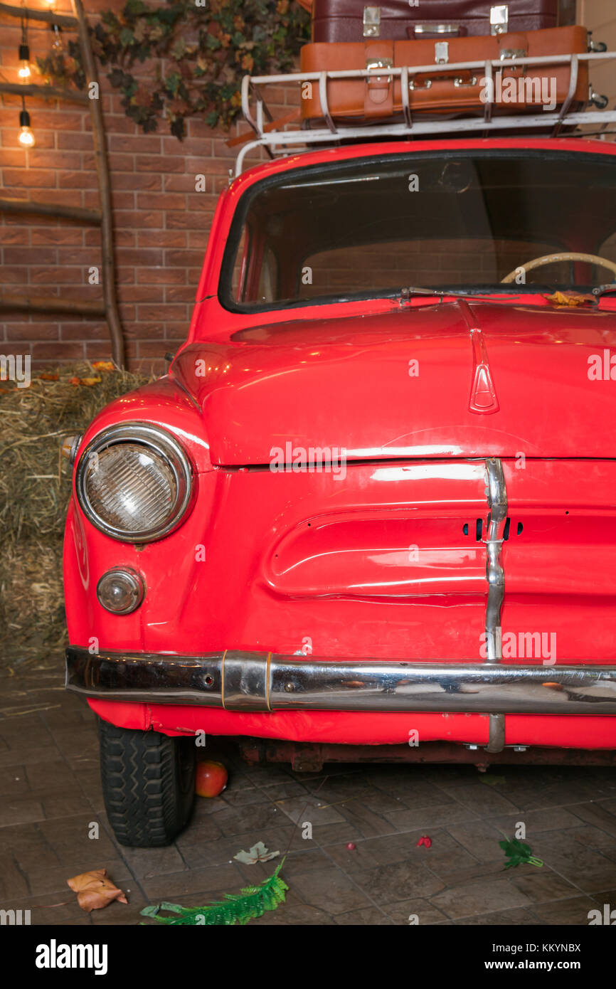 Retro red car on autumn scenery in front of the house Stock Photo - Alamy