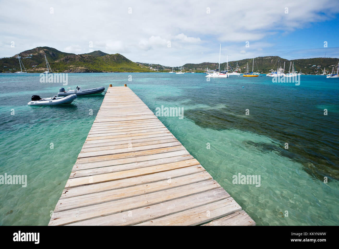 A little jetty and boats at Pigeon Beach in Antigua Stock Photo - Alamy