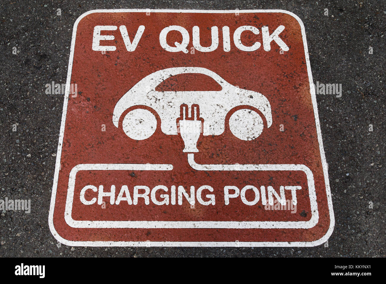 Electric vehicle (EV) quick charging point sign on the asphalt at the ...