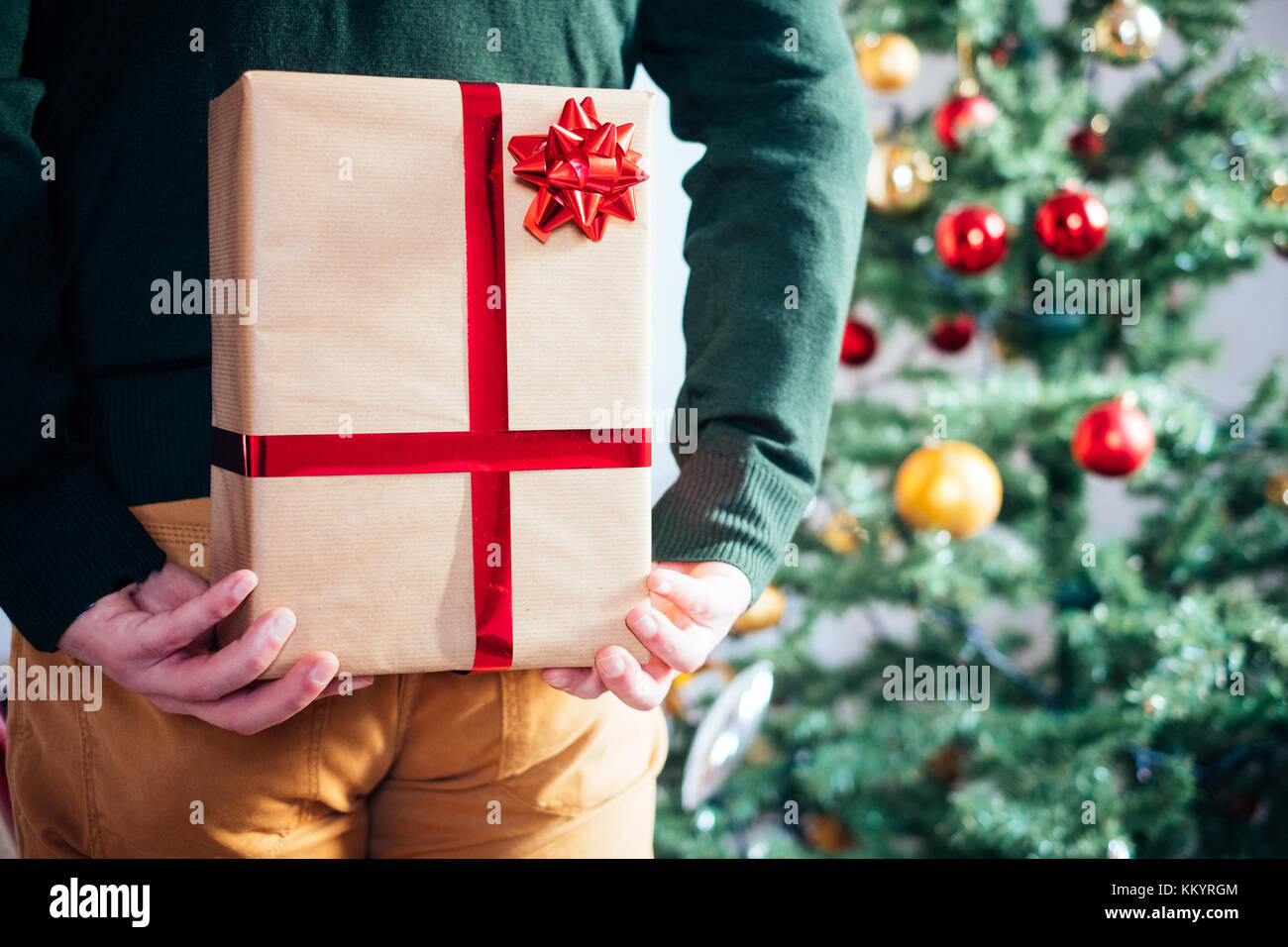 Man hiding a gift hi-res stock photography and images - Alamy