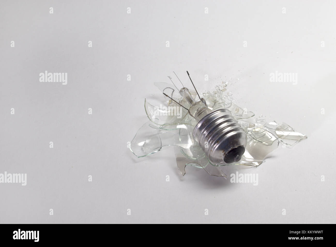 base of the broken bulb among the shards of glass Stock Photo - Alamy