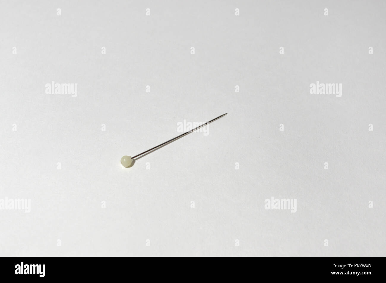tailor's pin with white ball-shape finial Stock Photo - Alamy
