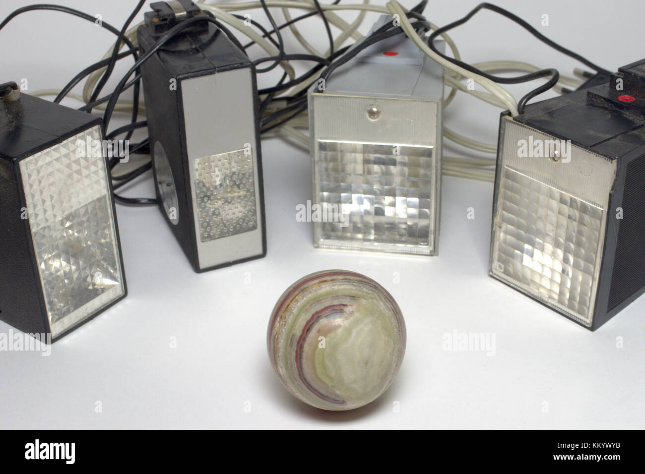 vintage electronic camera flashes, surrounding the ball of marble onyx ...