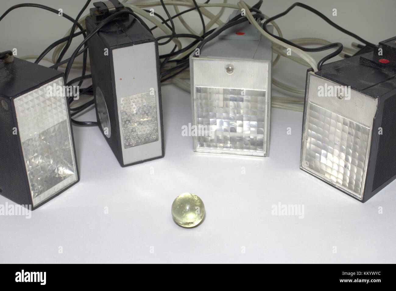 Old pulse electronic flashes, surrounding the small glass ball. Closeup ...