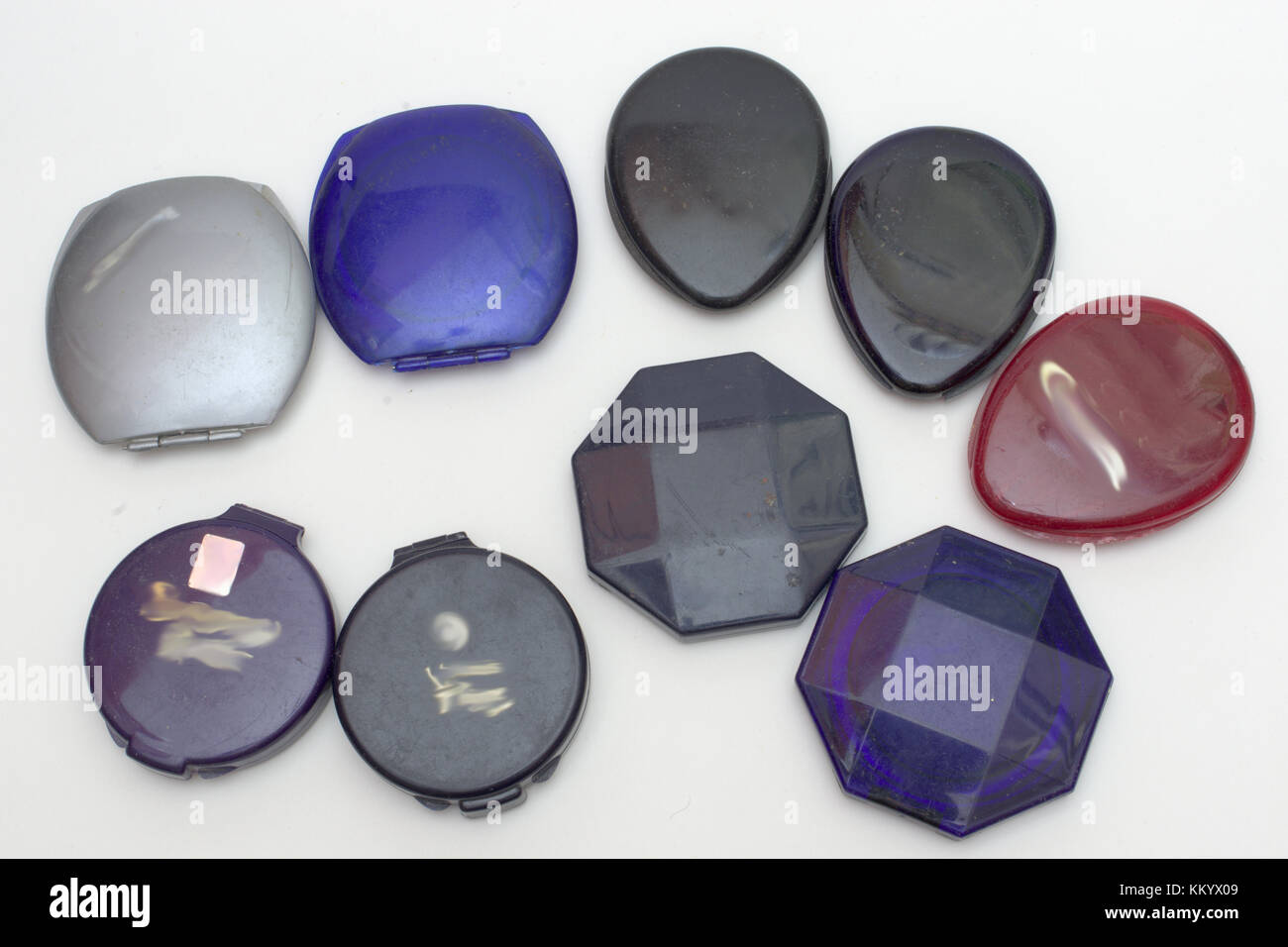 Set of powder cases different forms: drops, regular octagon, round and ...