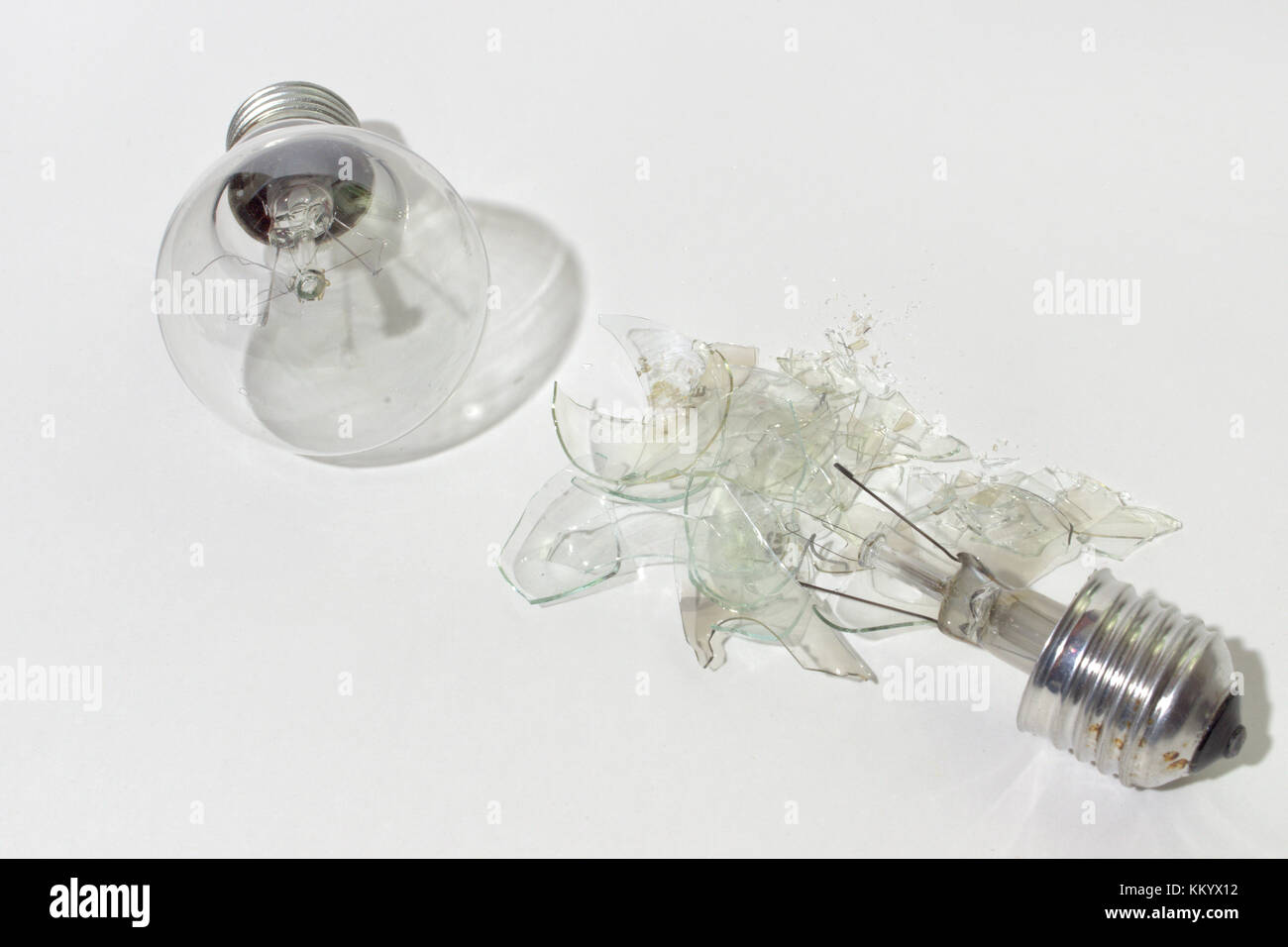 light bulb with a torn filament next to the shattered lamp Stock Photo ...
