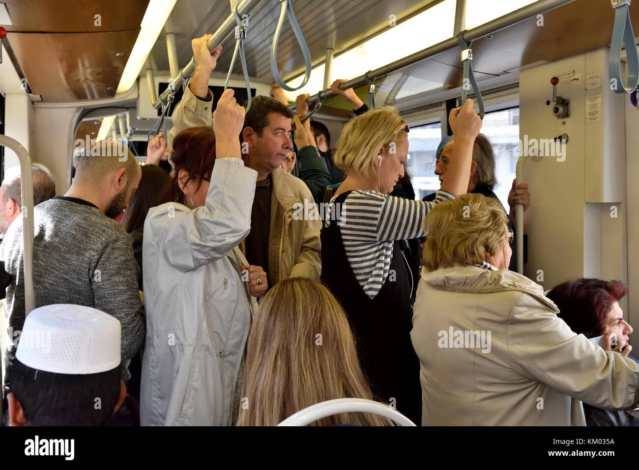 Inside crowded Athens tram with people standing, Greece Stock Photo - Alamy