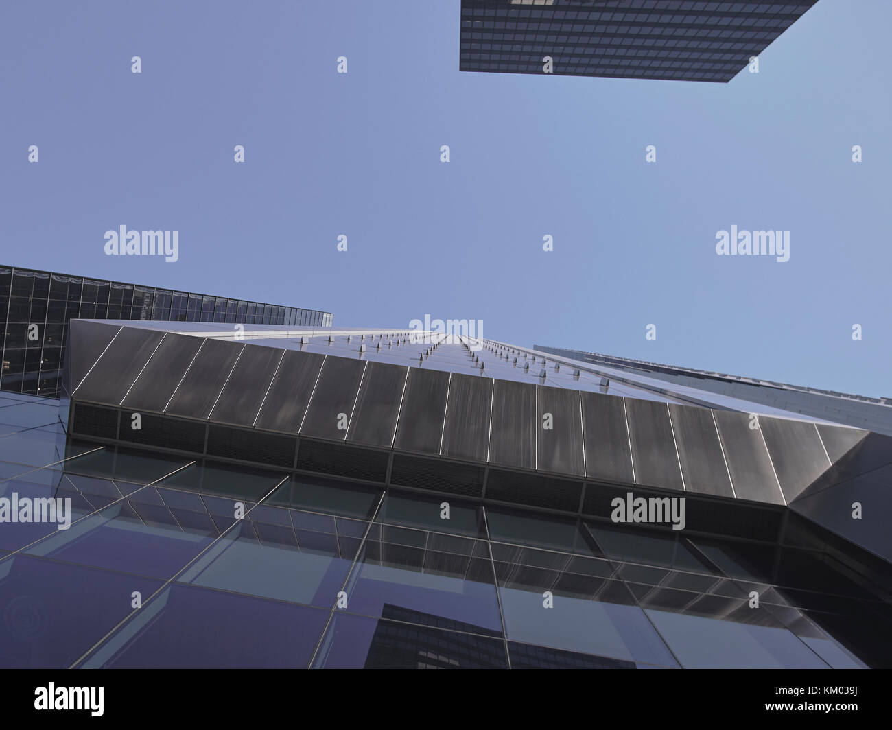 looking up between buildings at the sky and rooflines of skyscrapers ...