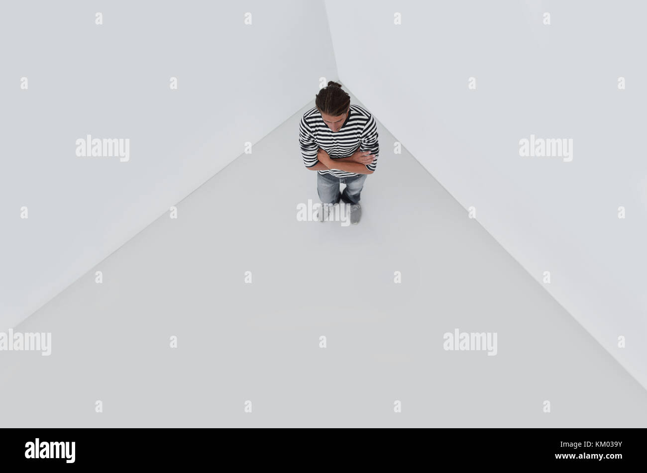 handsome guy standing near the white wall Stock Photo - Alamy