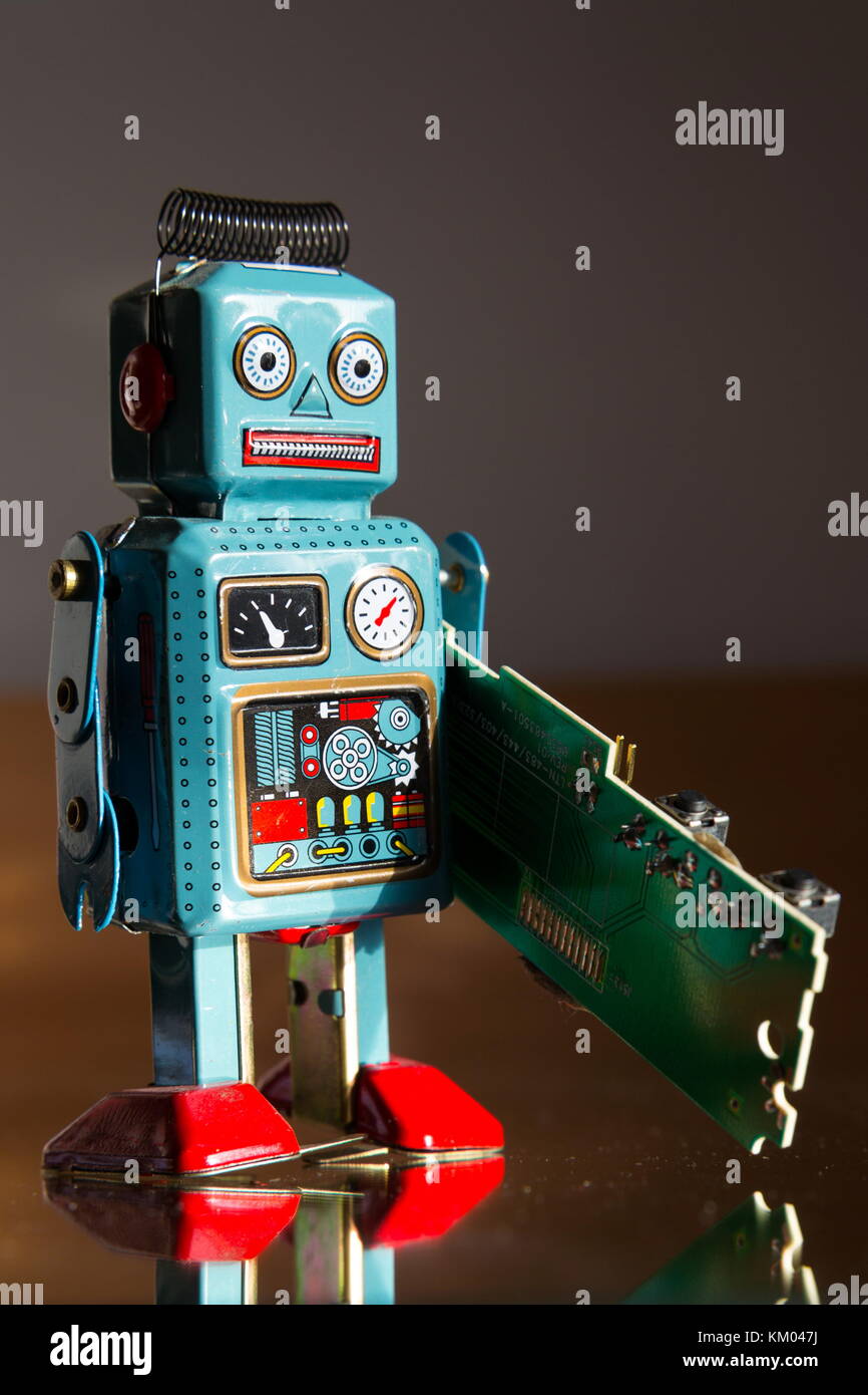 Tin toy robot carries computer circuit board, artificial intelligence ...