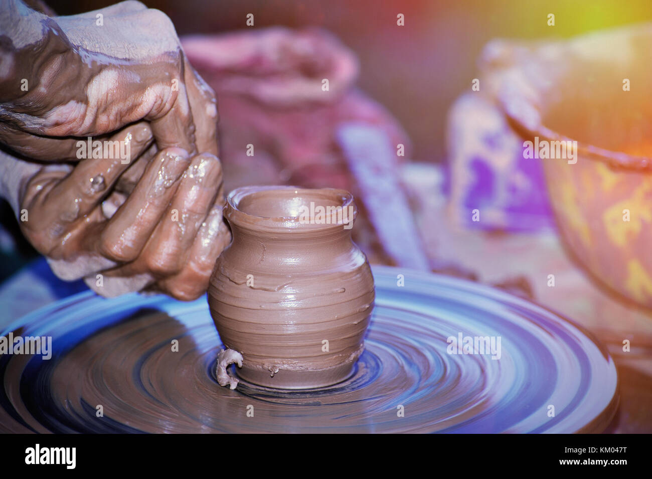 Traditional pottery making, close up of potter's hands shaping a bowl ...