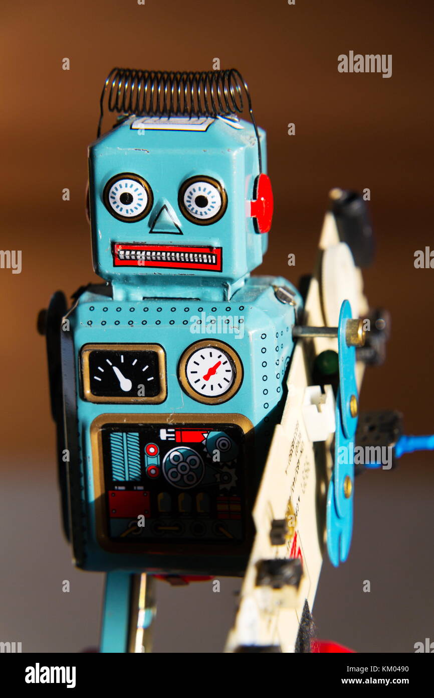 Tin toy robot carries computer circuit board, artificial intelligence ...