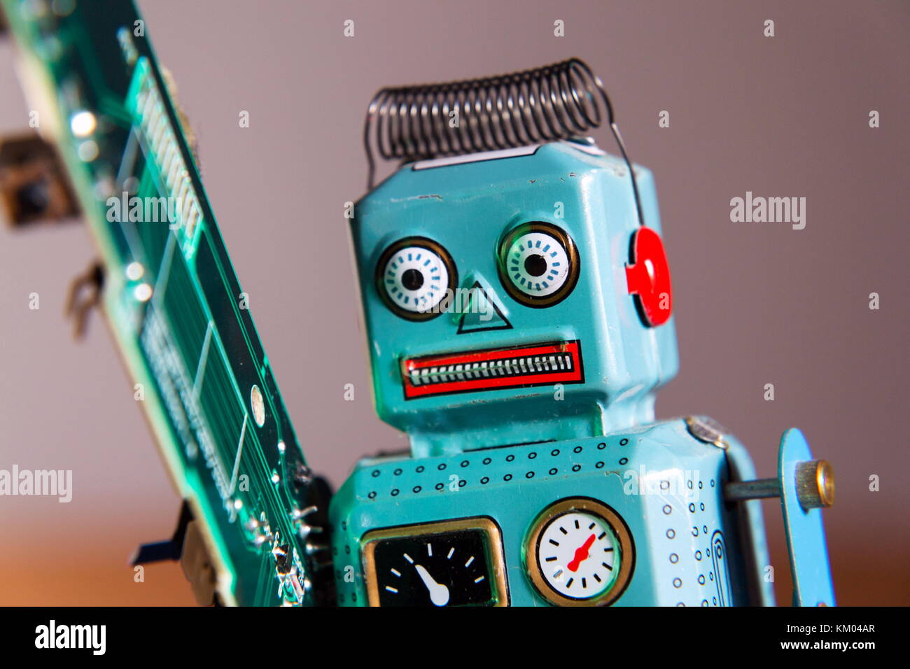 Tin toy robot carries computer circuit board, artificial intelligence ...