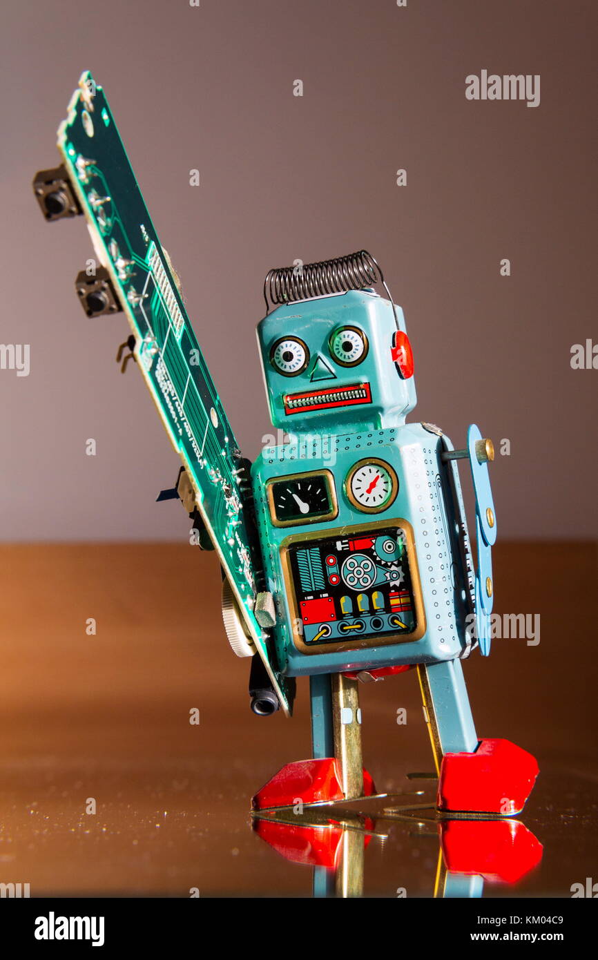 Tin toy robot carries computer circuit board, artificial intelligence ...