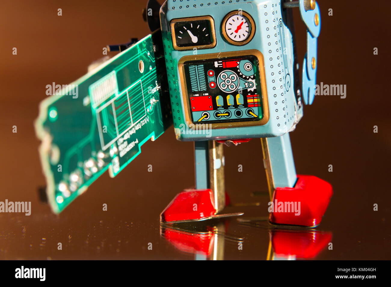 Tin toy robot carries computer circuit board, artificial intelligence ...