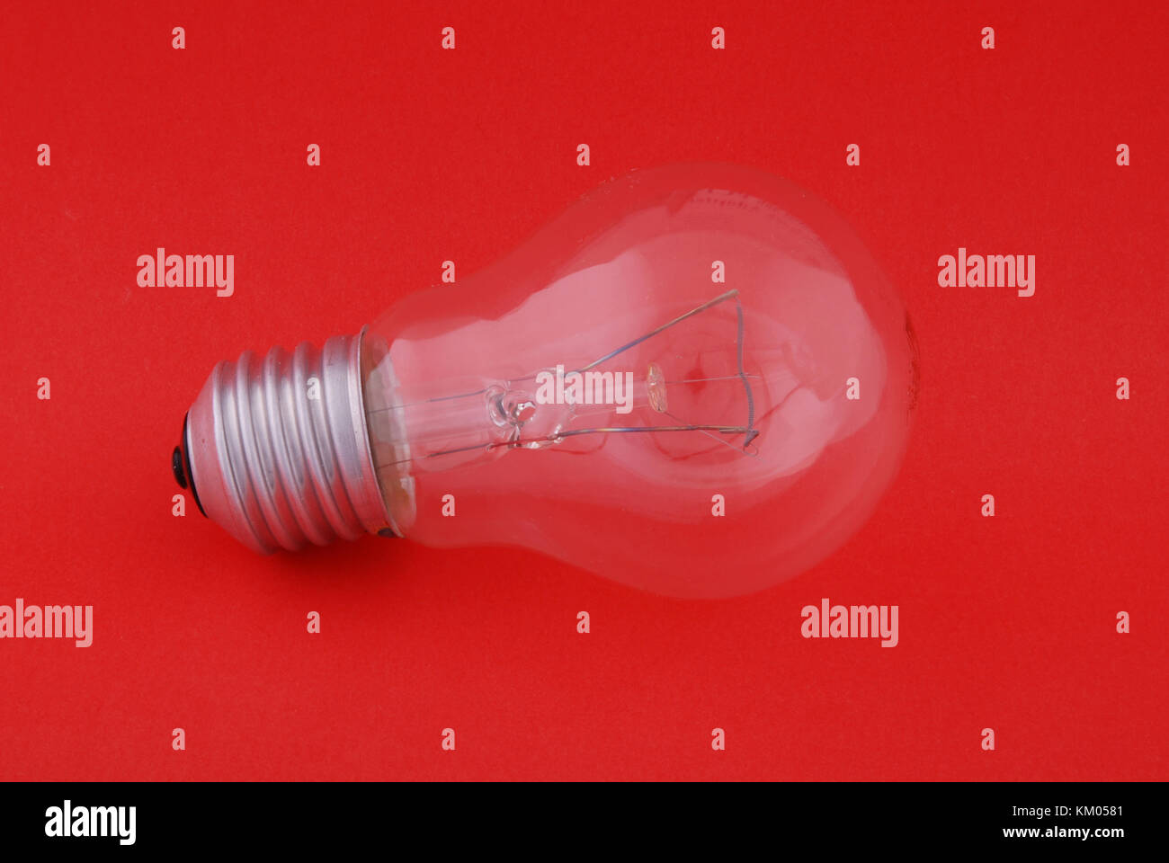 Light bulb on red background Stock Photo - Alamy