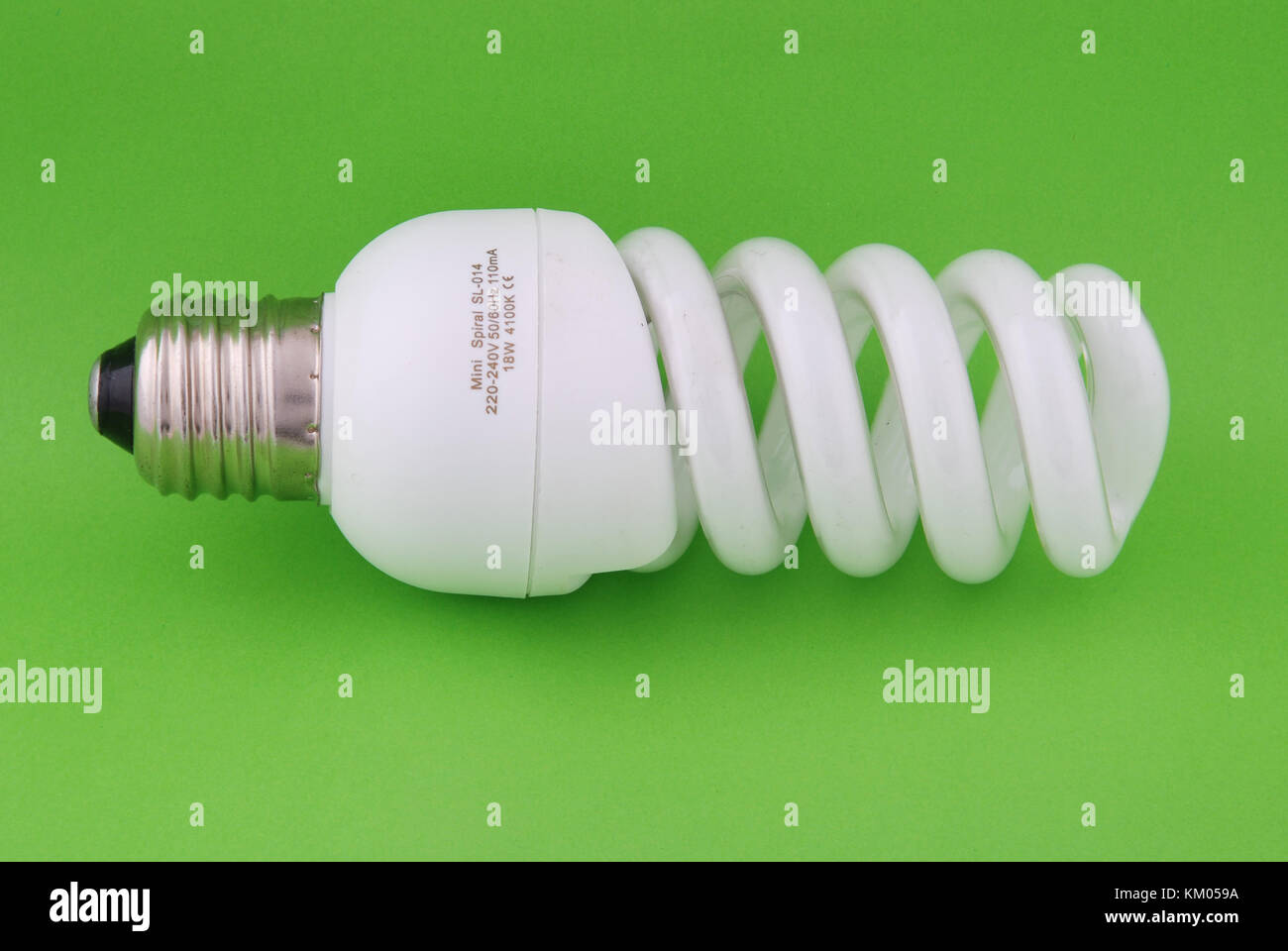 Compact Fluorescent Light Bulb. On green backlground Stock Photo - Alamy