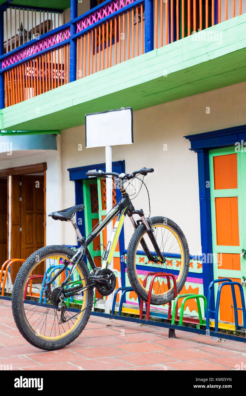 Lonely bicycle parked on a colorful rack at the beautiful Guatape city ...