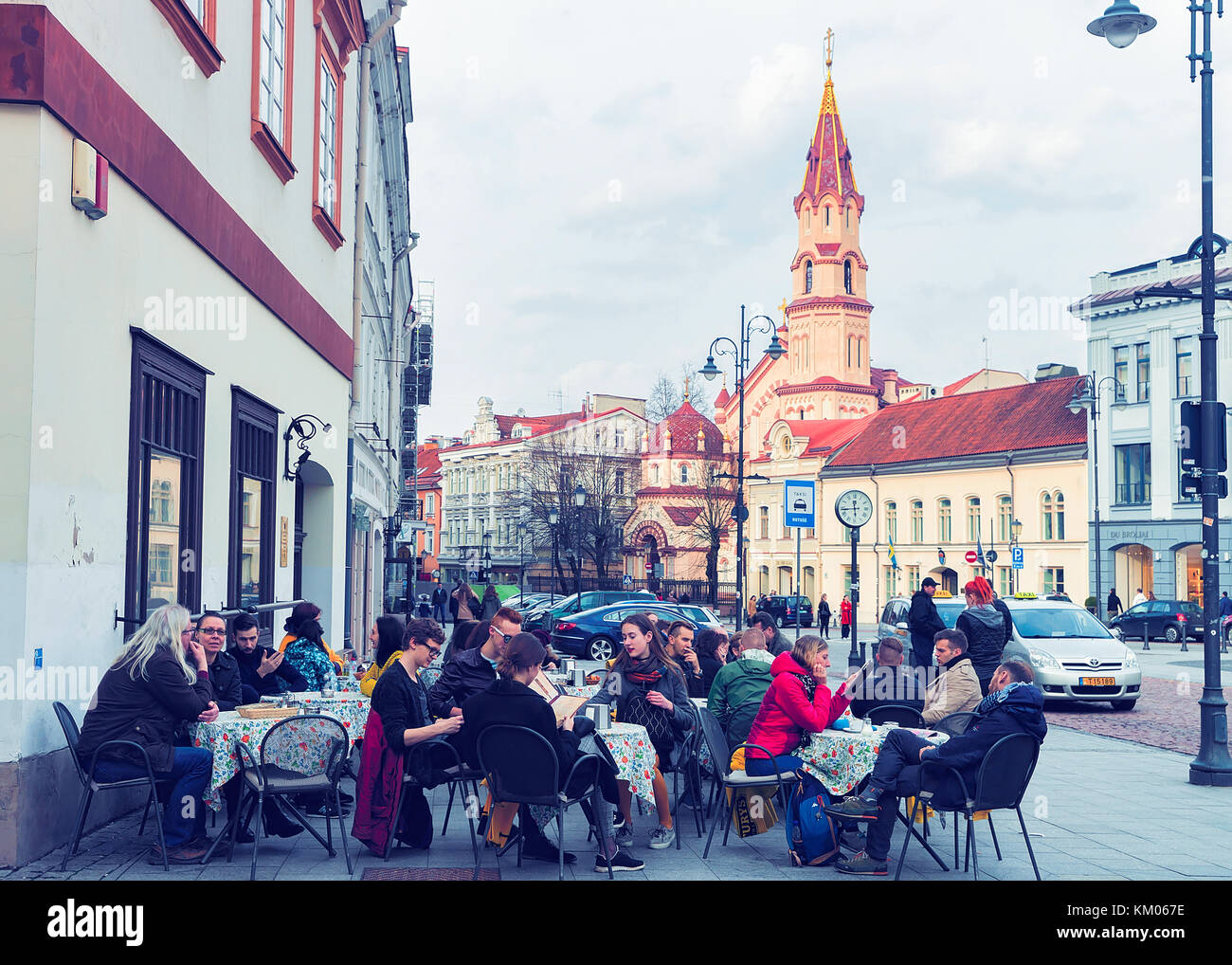 Vilnius, Lithuania - April 1, 2017: Tourists sitting in open air street ...