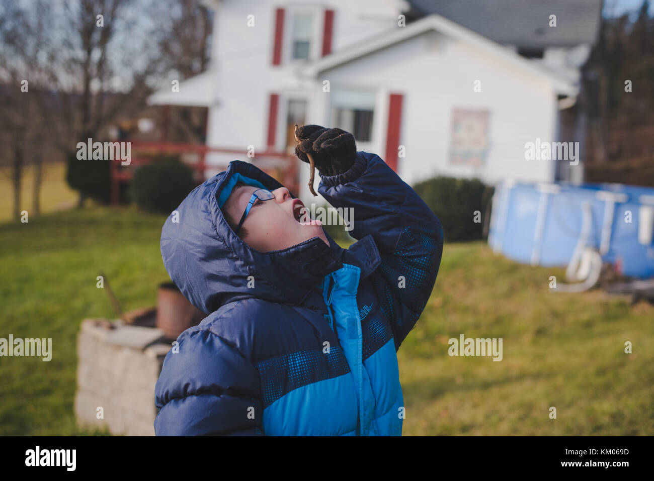 A boy pretends to eat a worm Stock Photo - Alamy