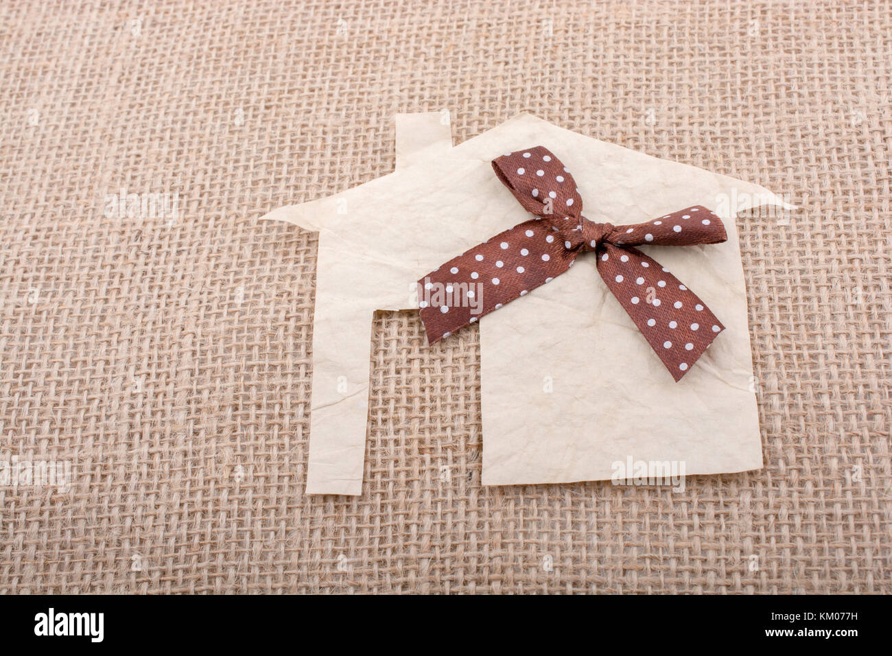 Little house shape cut out of paper on a canvas background Stock Photo ...