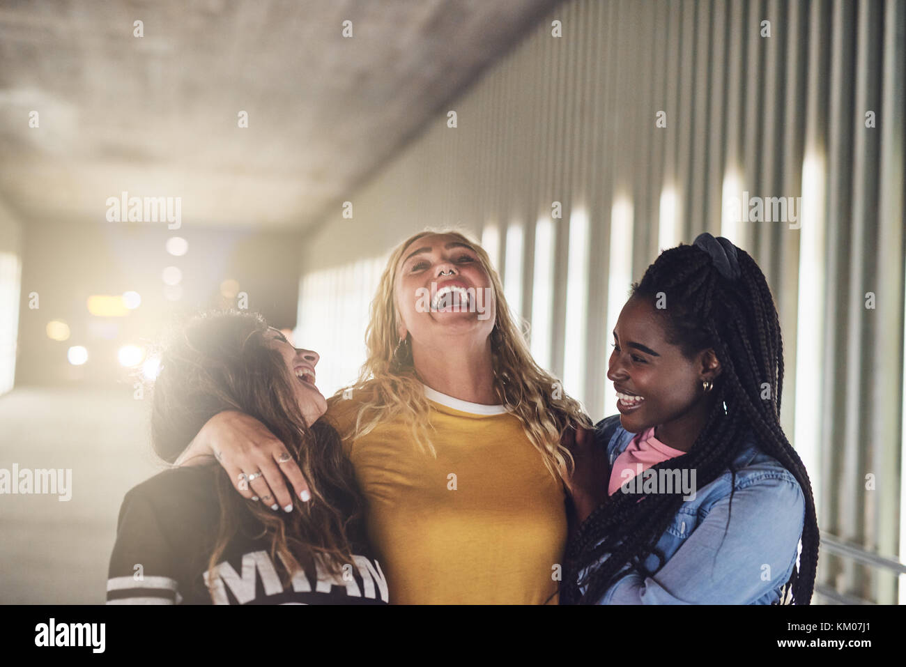 Diverse group of young girlfriends laughing and having fun while ...