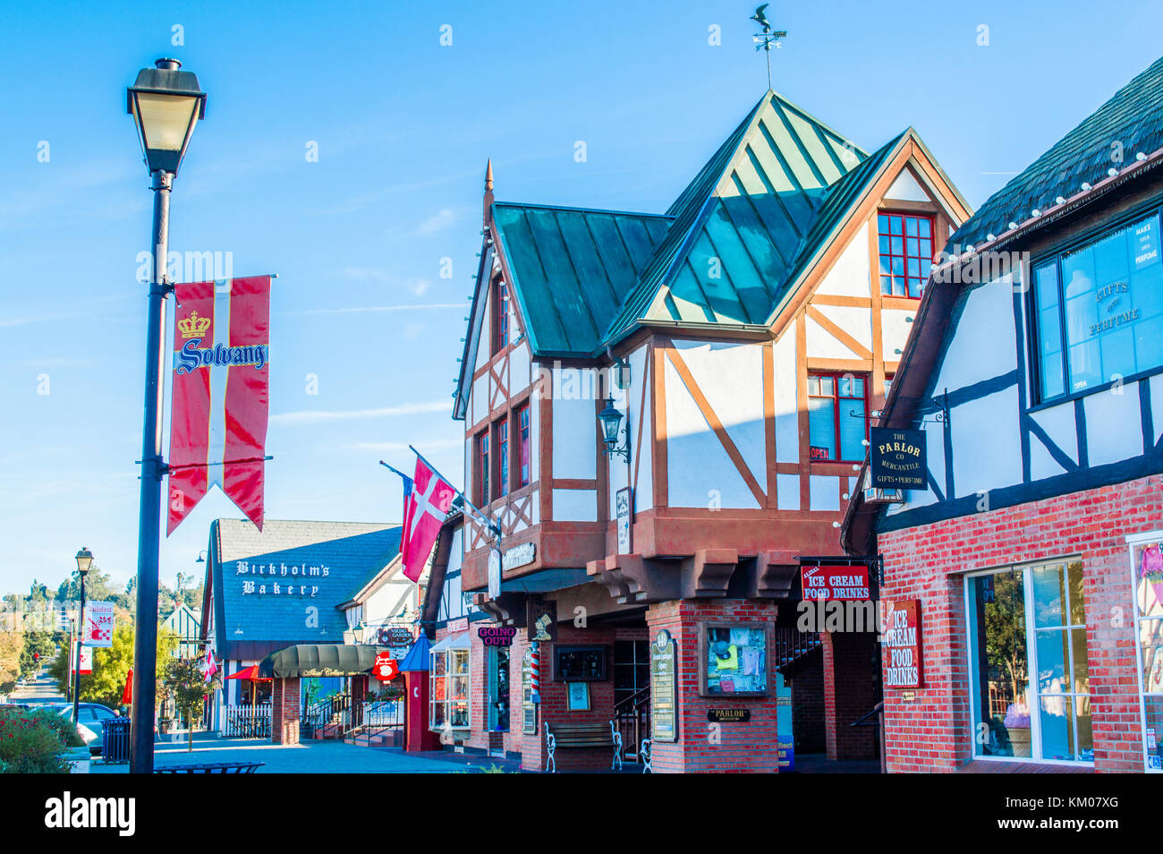 shops in quaint Danish style buildings with early morning sunlight in ...