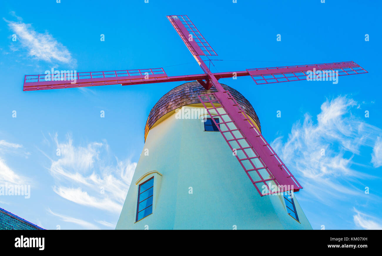 vintage red and white windmill with early morning sunlight in Solvang ...