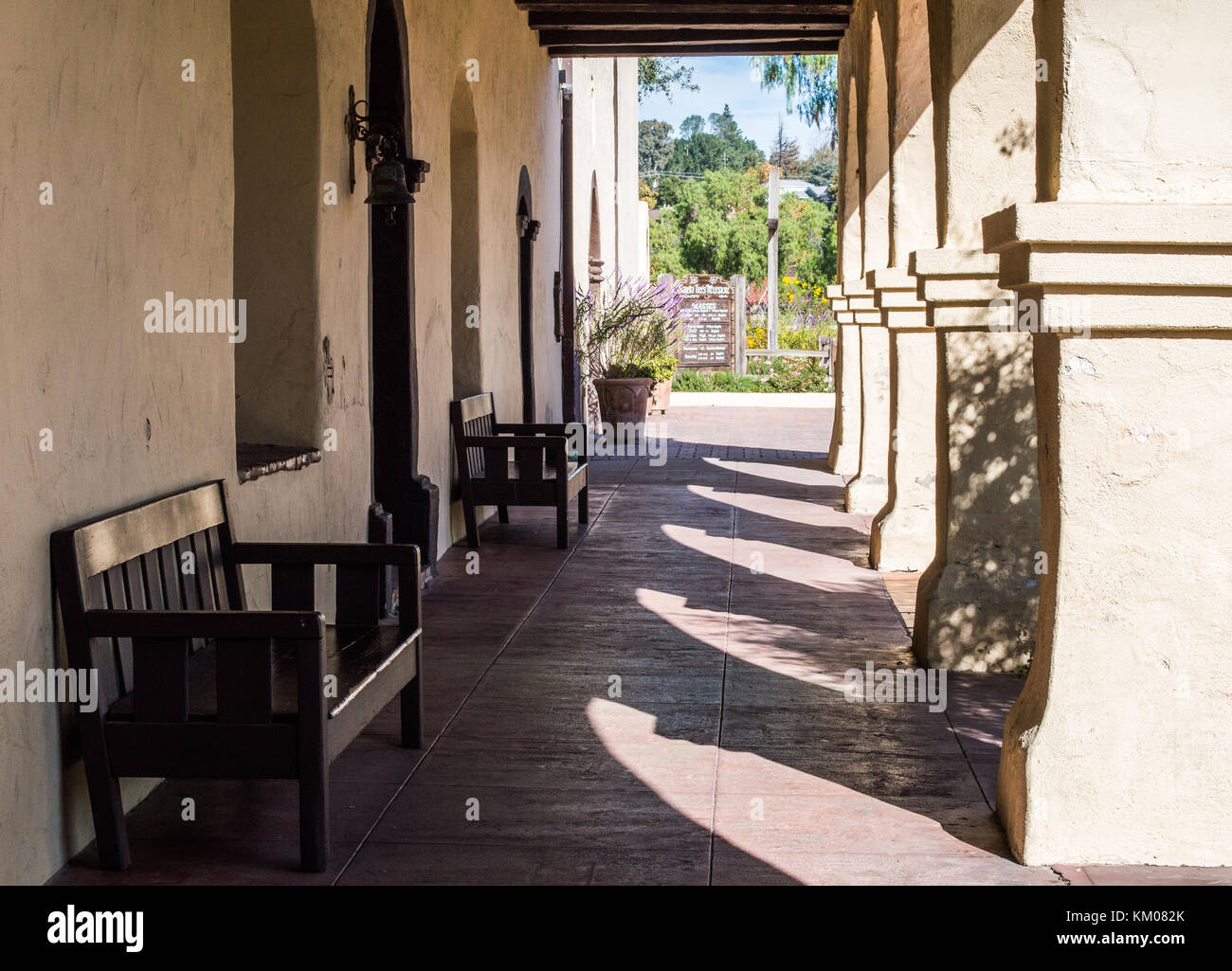 outdoor veranda at a California mission with early morning sunlight and ...