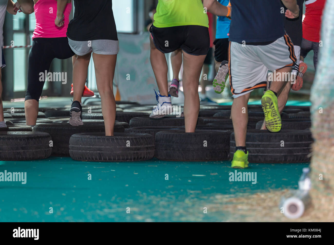 People Running over the Tyre During Fitness Obstacle Exercise Stock ...