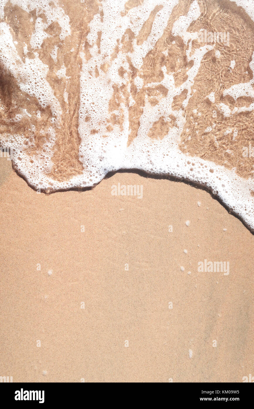 Transparent soft wave on sandy beach Stock Photo - Alamy