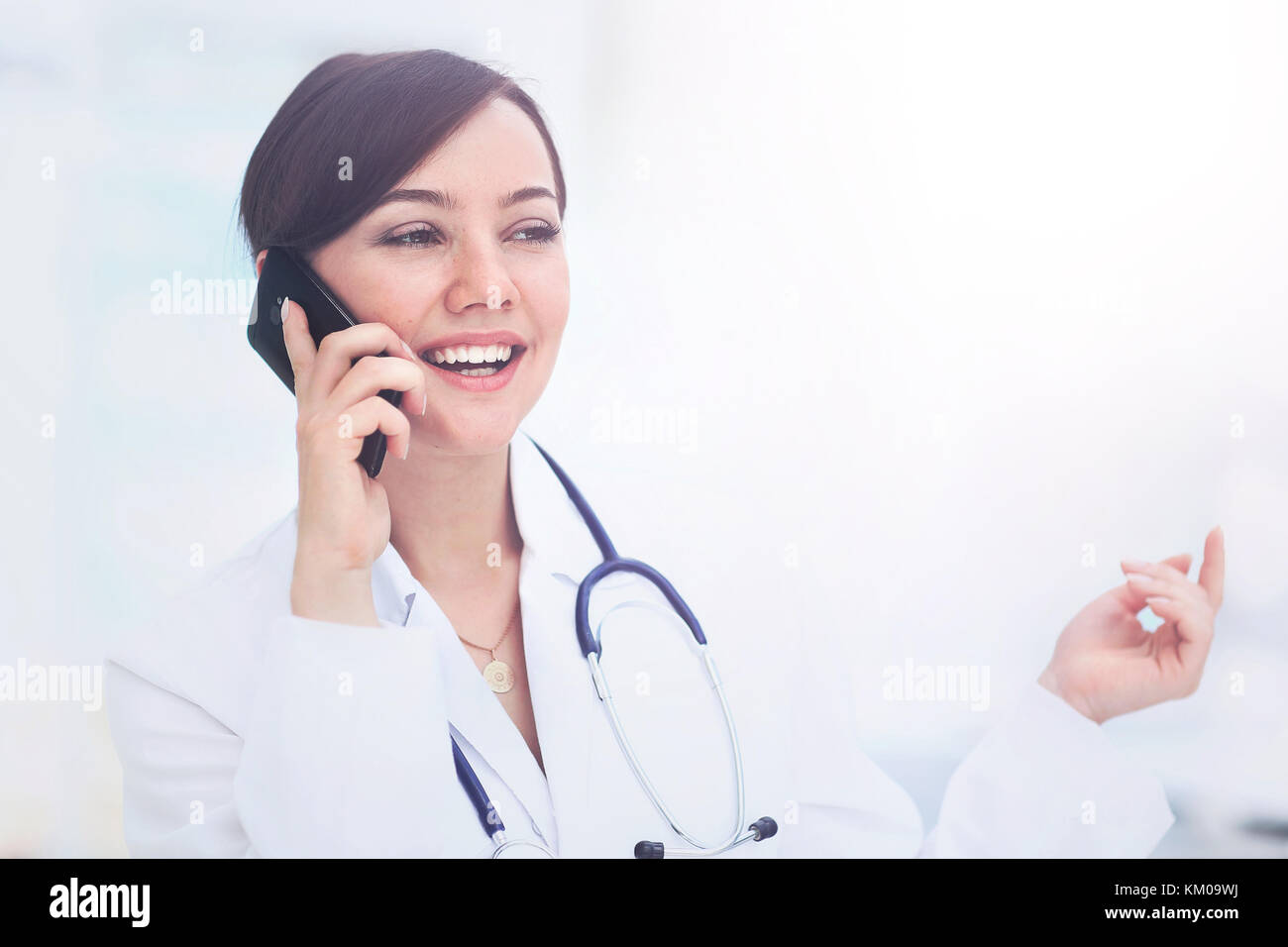 Doctor talking on telephone Stock Photo - Alamy