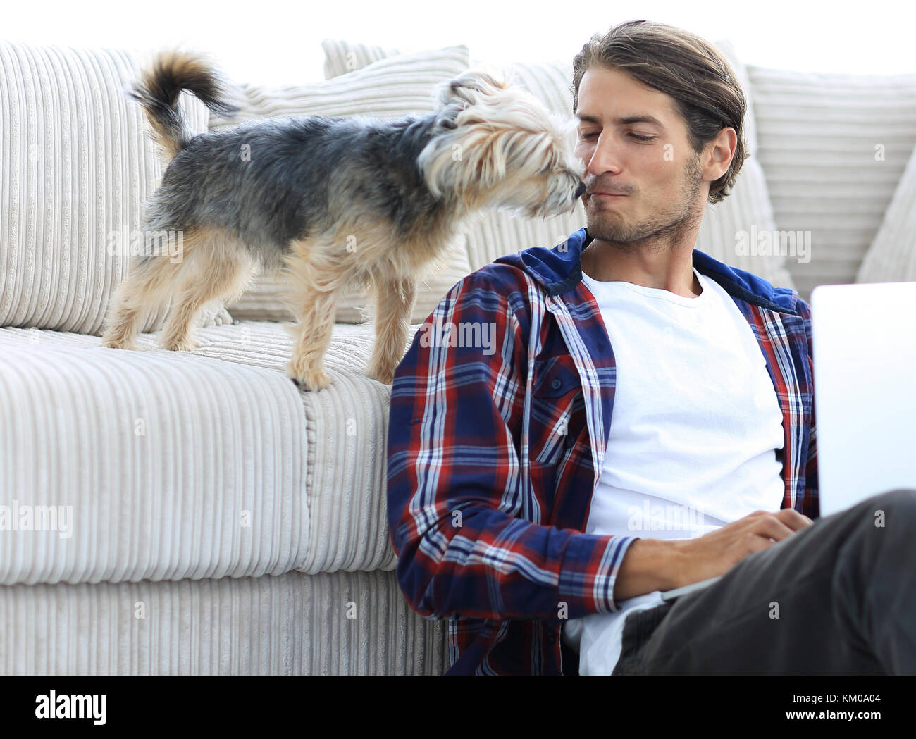successful guy and his favorite pet in a cozy living room Stock Photo ...