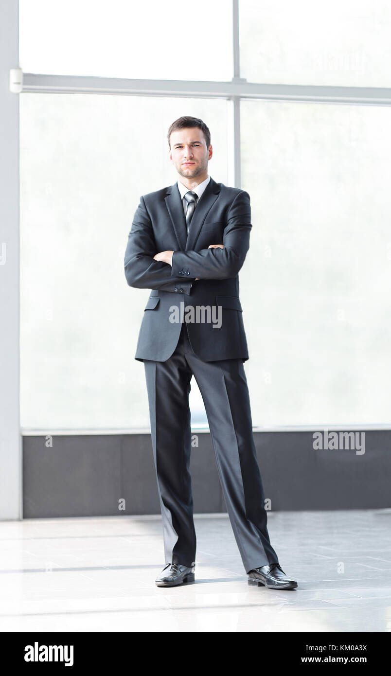 successful businessman standing in the lobby of the office Stock Photo ...
