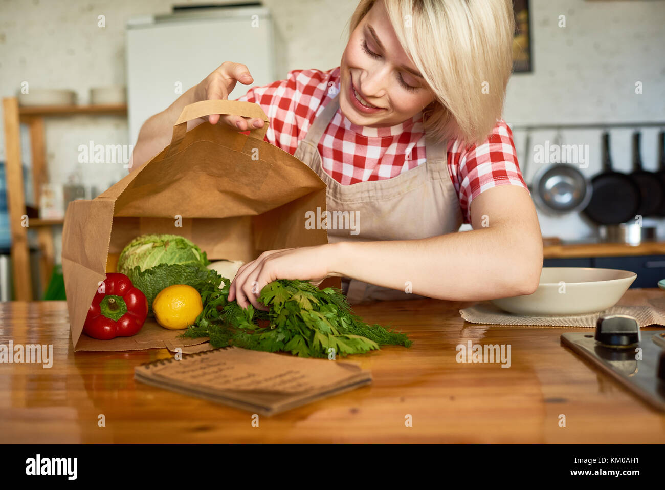 Pretty woman unpacking vegetables hi-res stock photography and images ...