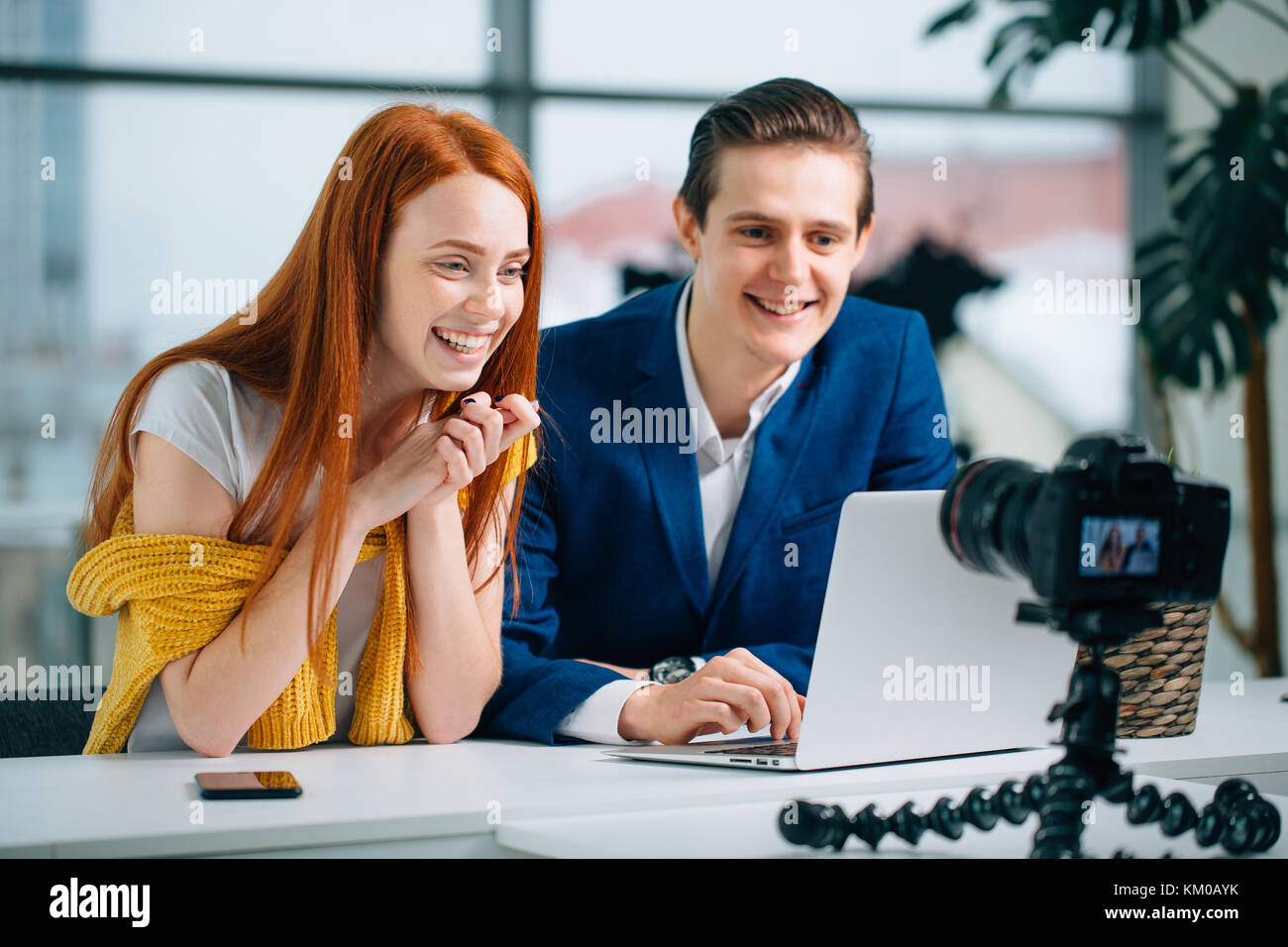 two video blogger talk about something and smiling Stock Photo - Alamy