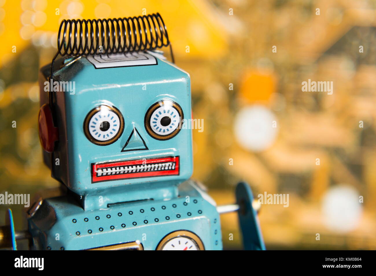 Vintage tin toy robot behind computer board, artificial intelligence ...