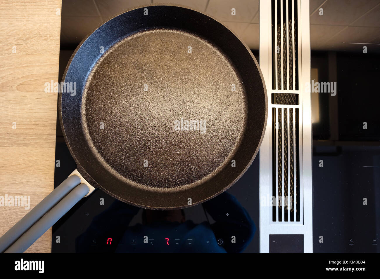 Cast iron frying pan on a glass induction cooker Stock Photo - Alamy